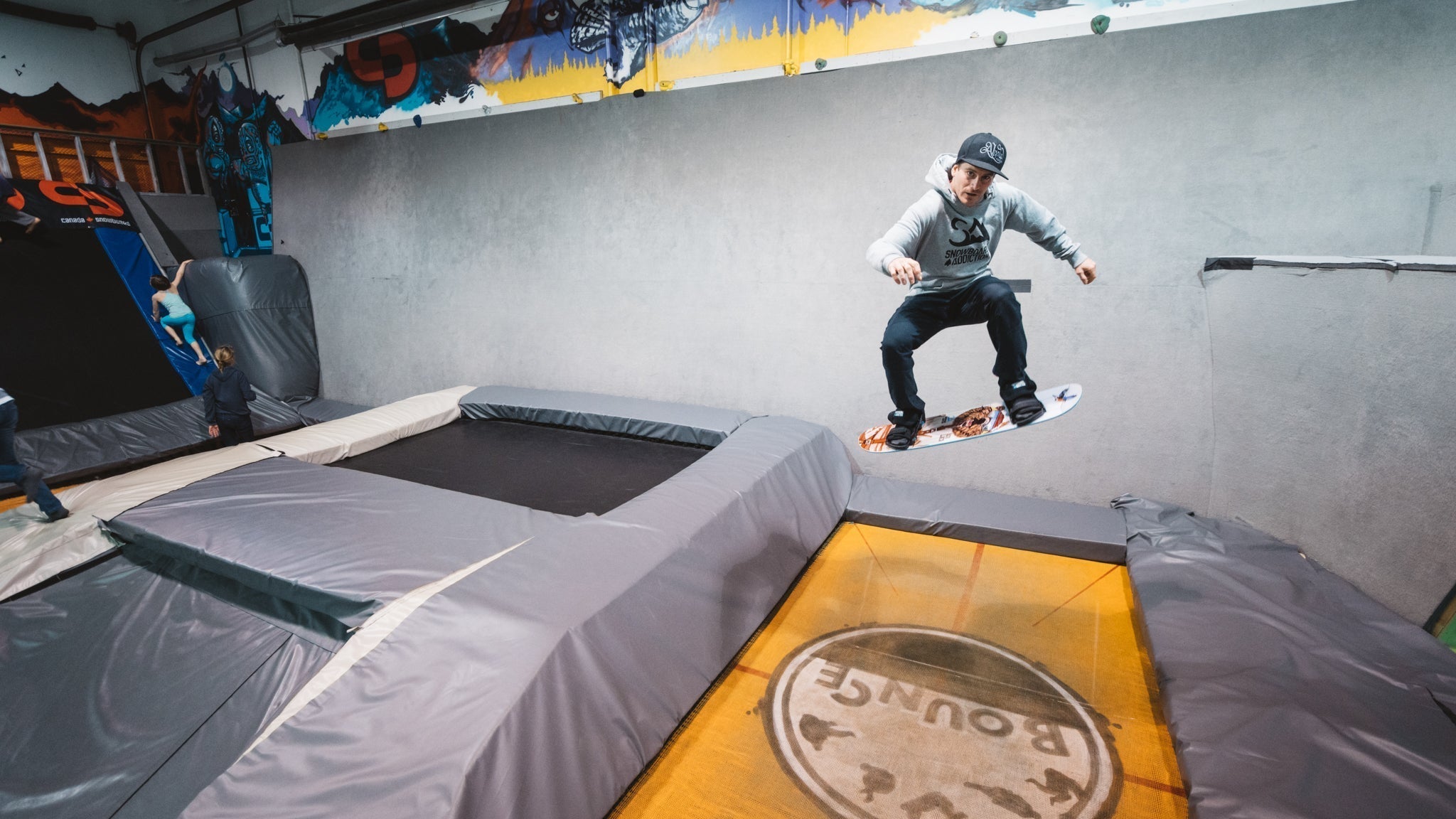 How To Frontside & Cab 180 On A Tramp Board – Snowboard Addiction